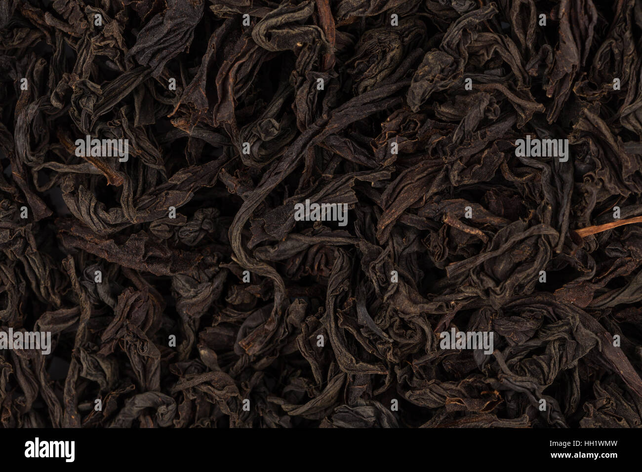 Black dry tea leaves close up for background Stock Photo - Alamy