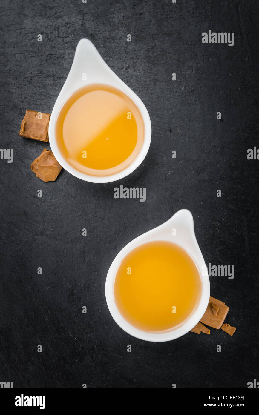 Syrup (Caramel taste) on a vintage slate slab (close-up shot; selective ...