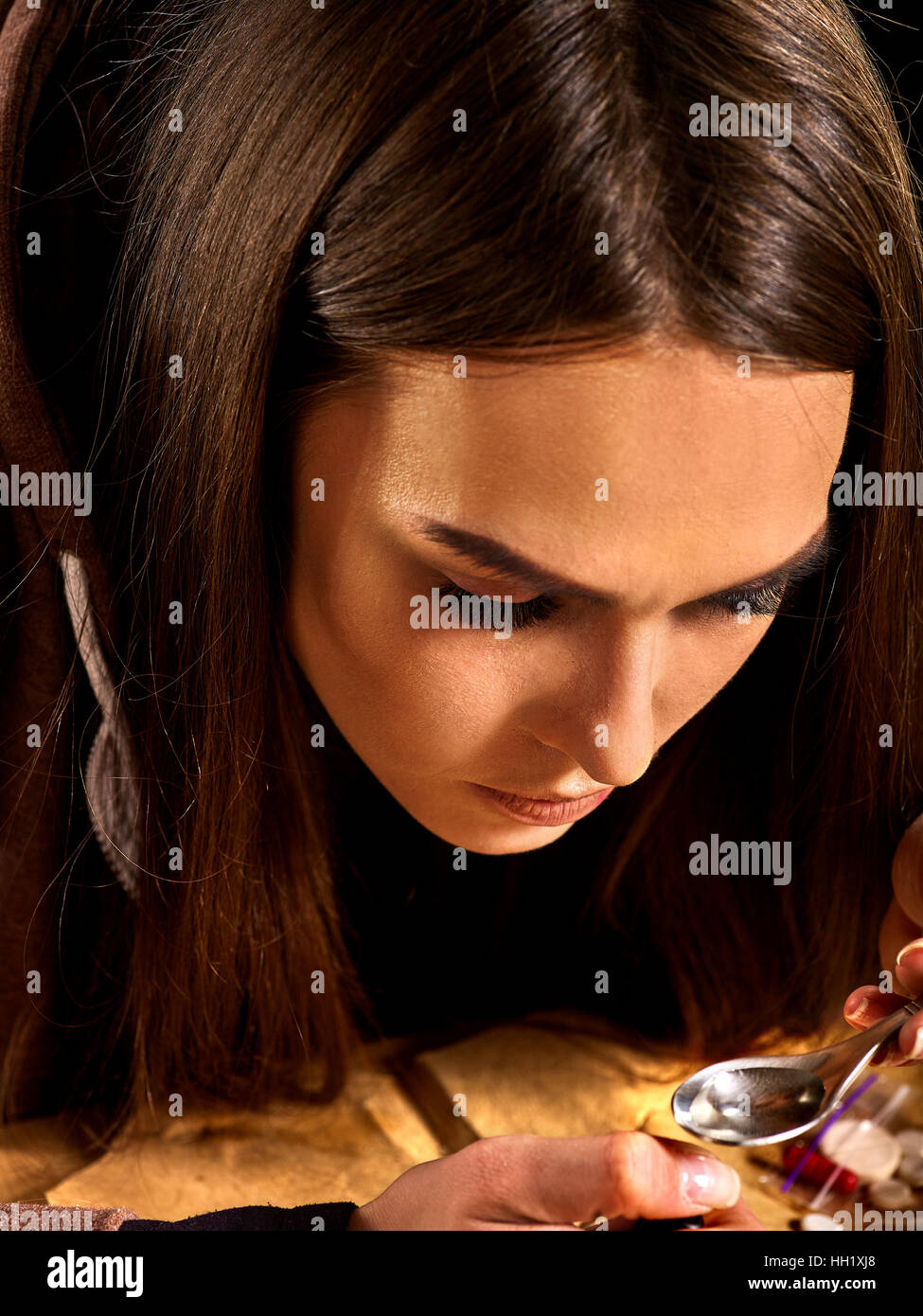 Woman addict use heroin narcotic . Junkie with spoon cooking drug Stock ...