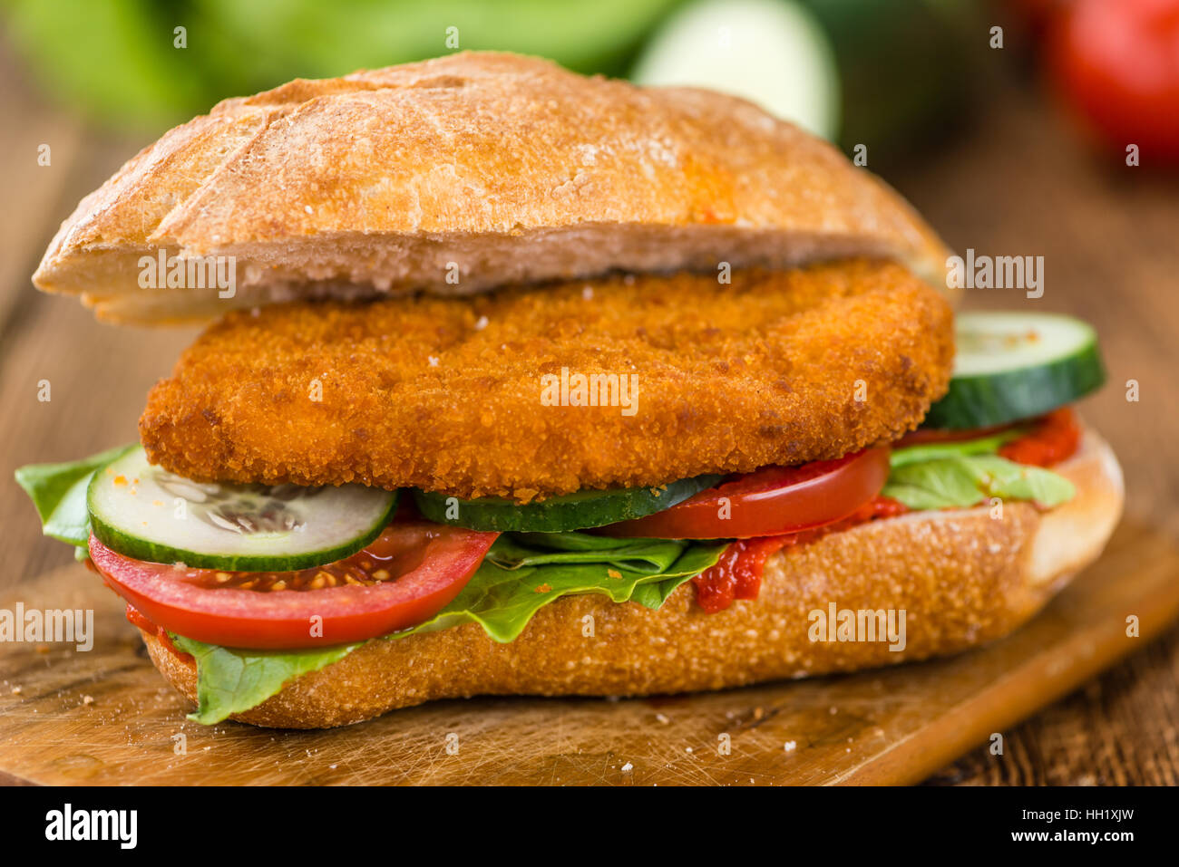 Fresh made Chicken Schnitzel on a bun (close-up shot; selective focus ...
