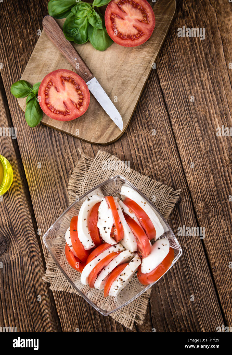 Portion of Mozzarella with Tomatoes (detailed close-up shot; selective ...