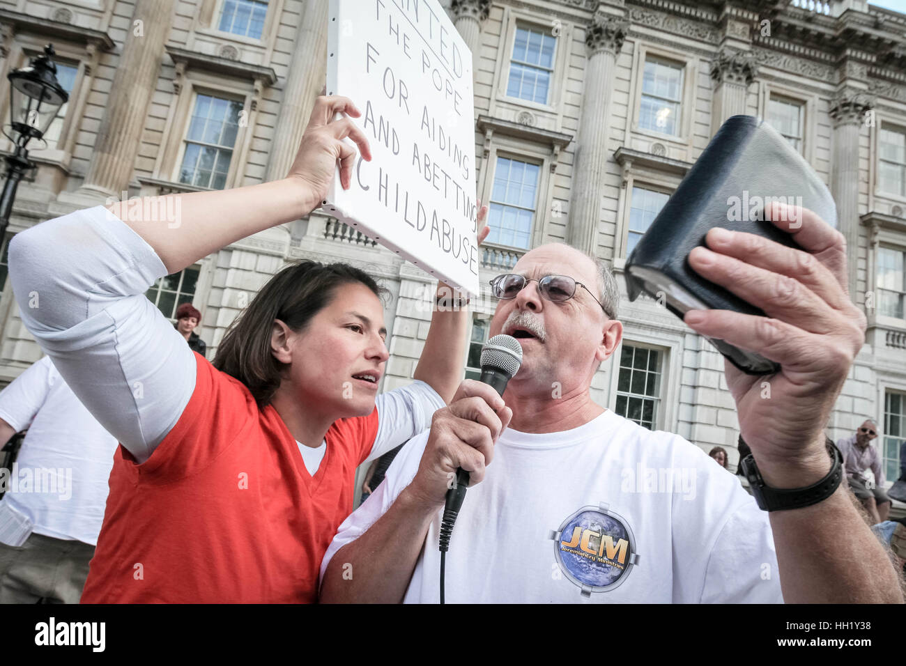 An anti-pope protester with placard tries to silence a vocal U.S ...
