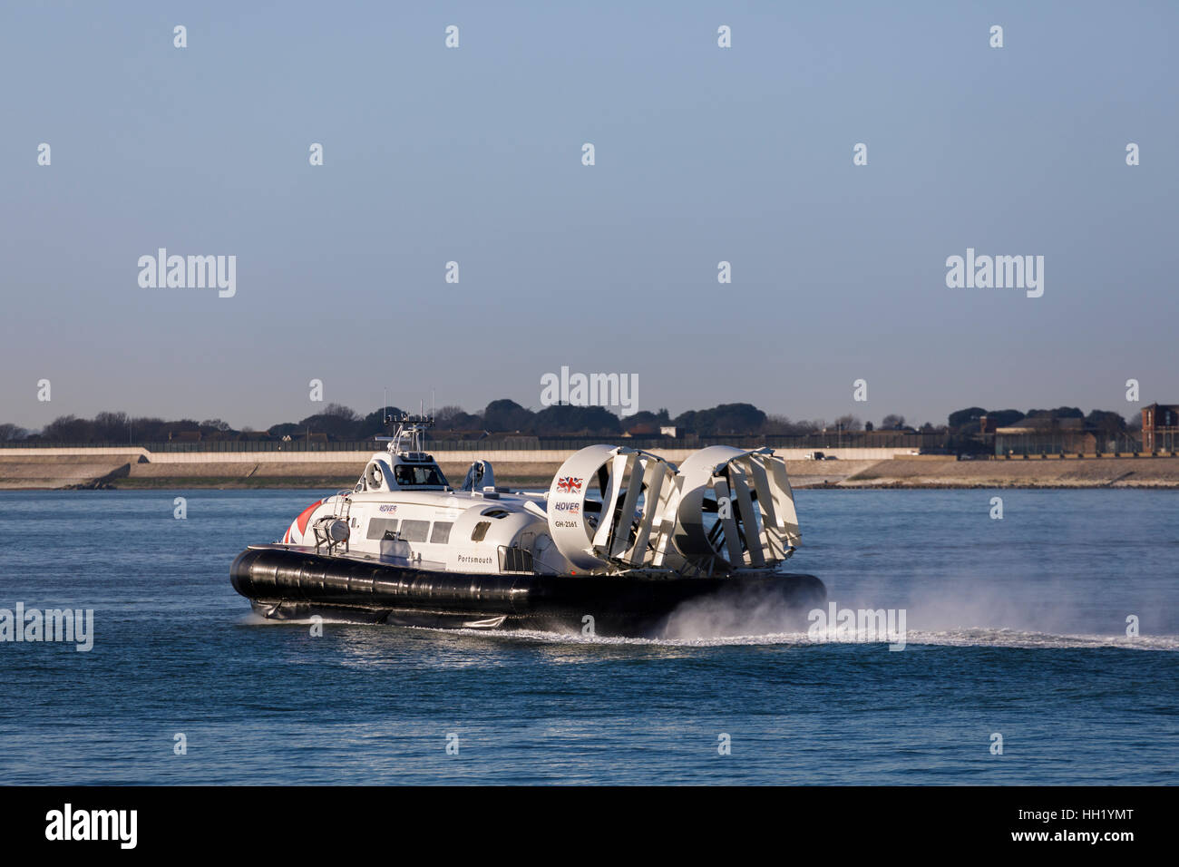 Hover Travel hovercraft departing at speed in a cloud of spray from the ...