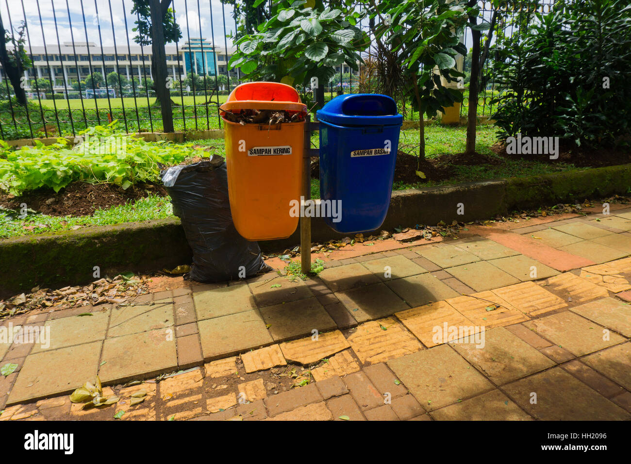 Organic and unorganic trash bin in pedestrian photo taken in Jakarta ...