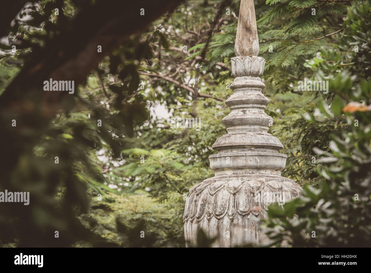Buddhist stupa top through trees near Wat Phnom, Cambodia Stock Photo ...