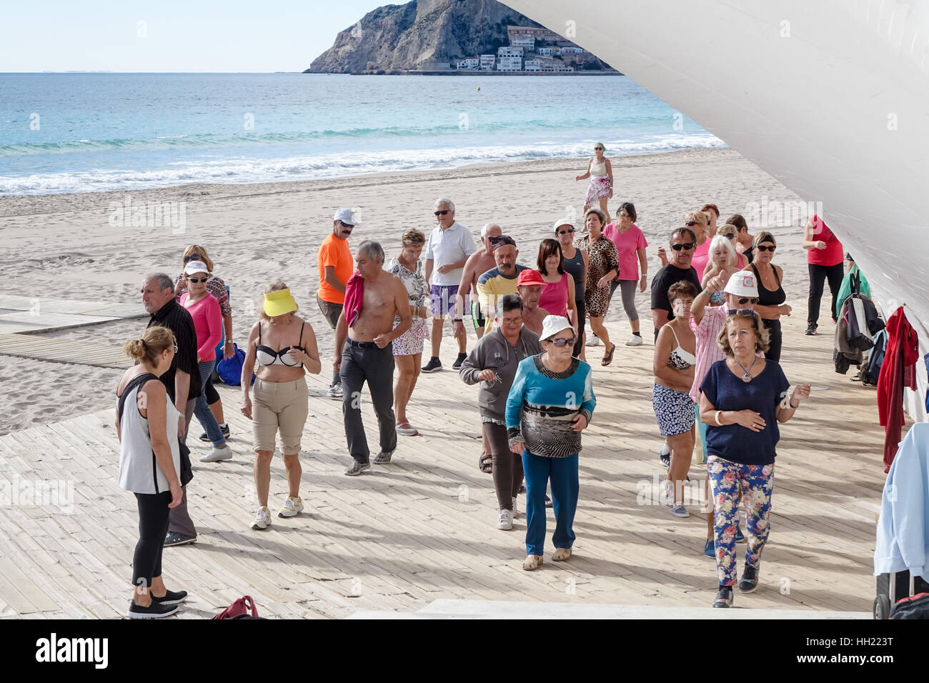 Old age pensioners, locals and tourists exercising on the beach in ...