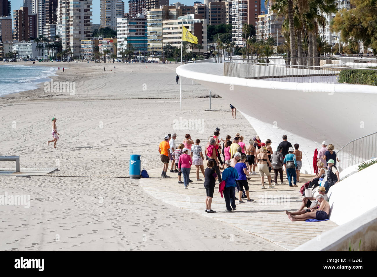 Old age pensioners, locals and tourists exercising on the beach in ...