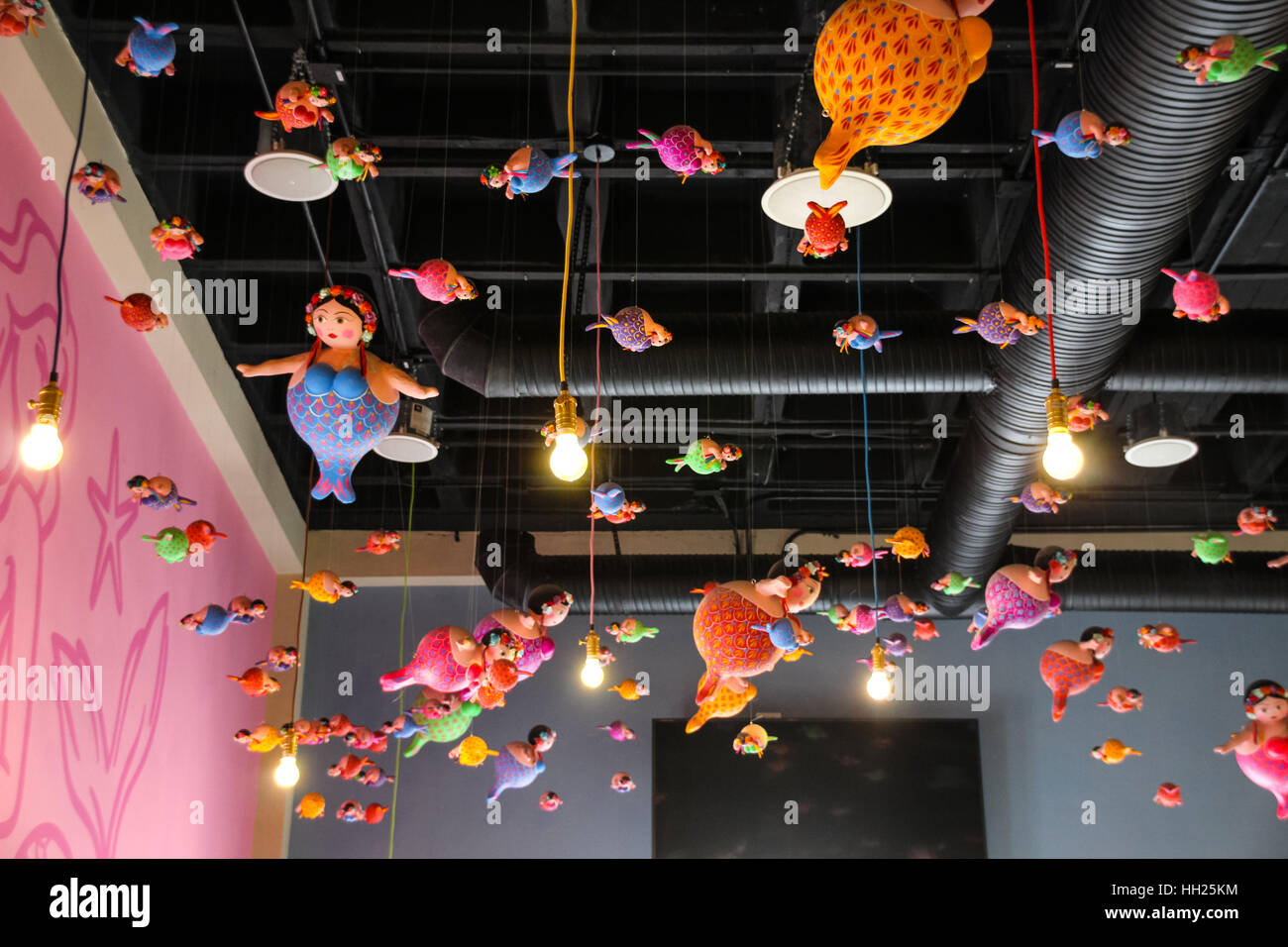 Photograph of some toy fat mermaids hanging,from the roof Stock Photo ...