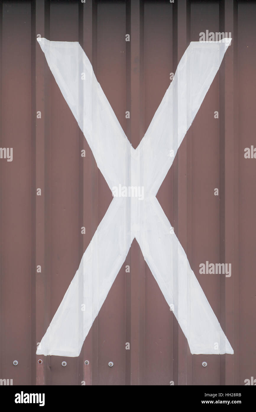 White letter X painted on a brown background Stock Photo - Alamy