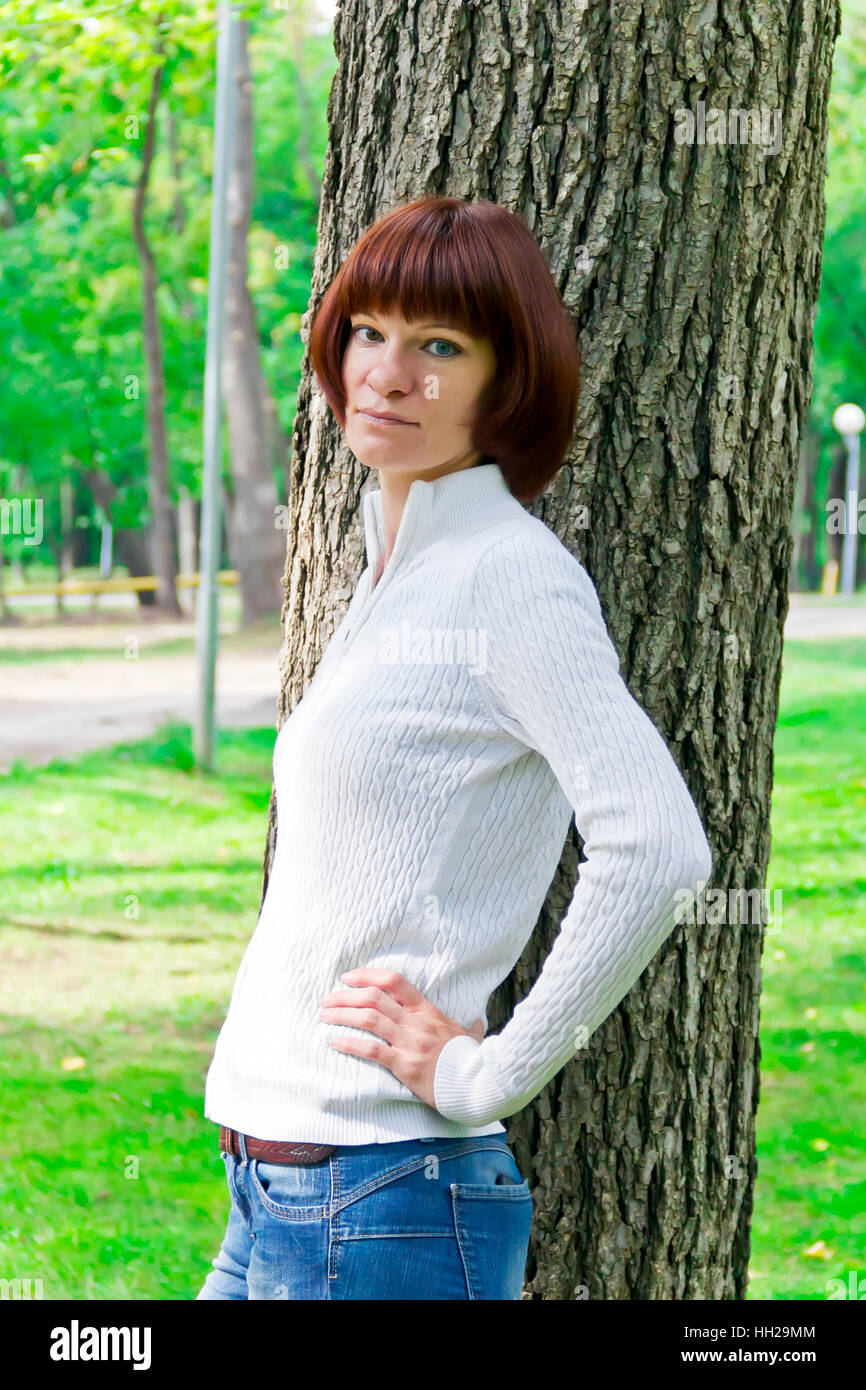 Photo of woman with brown hair near tree Stock Photo - Alamy