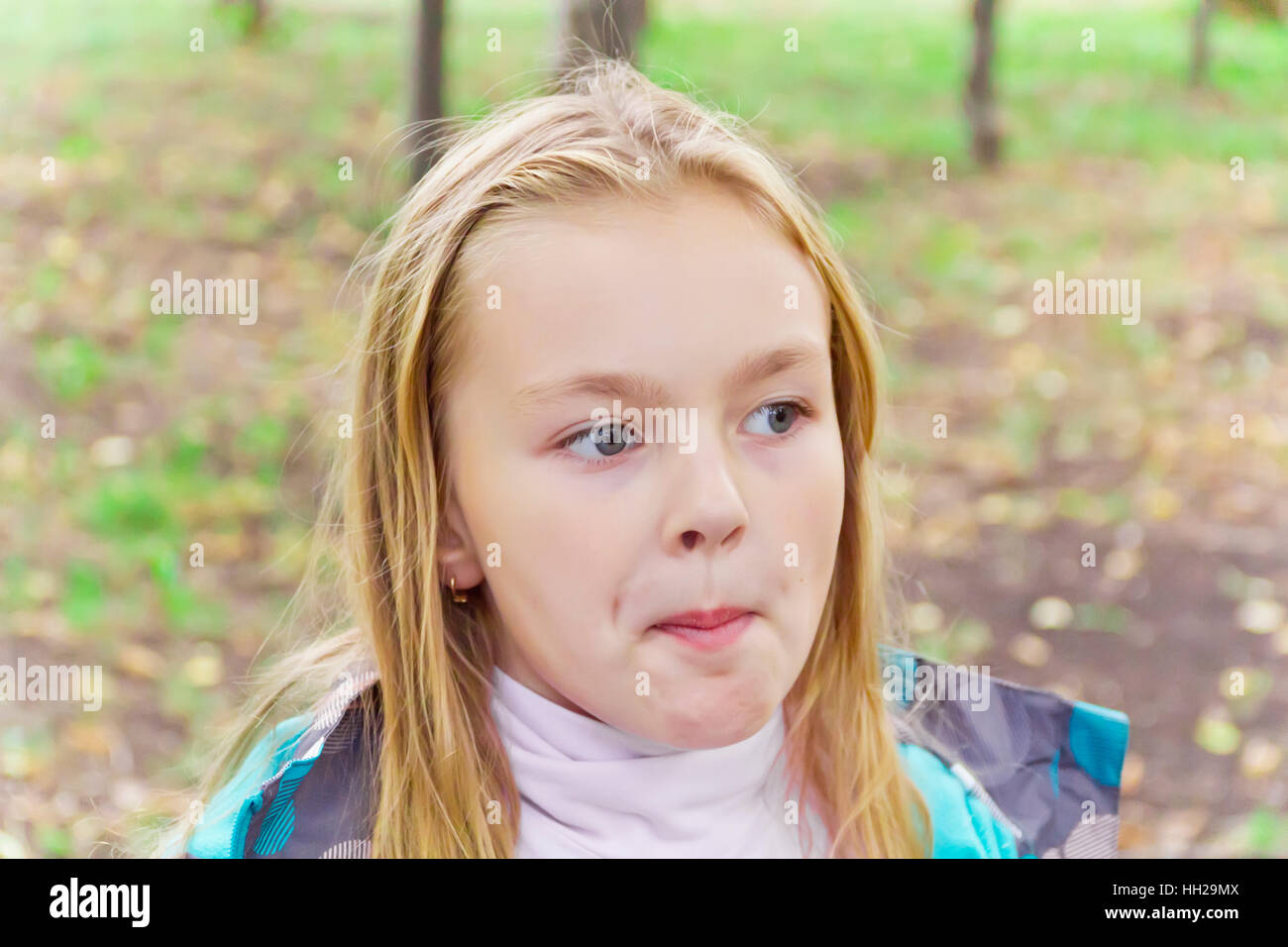 Photo of chewing cute girl with blond hair Stock Photo - Alamy