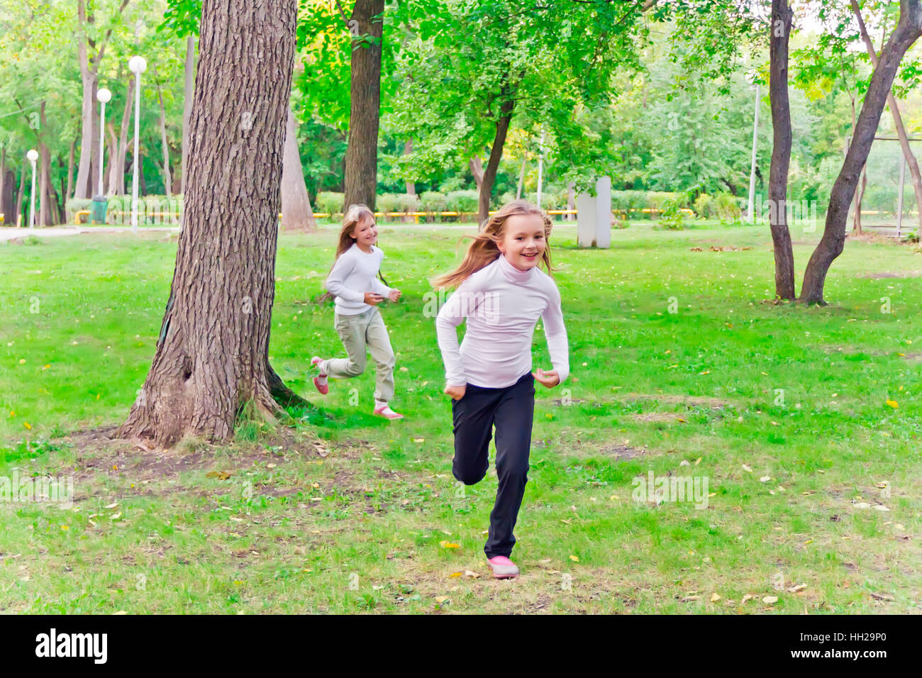 Two girls running hi-res stock photography and images - Alamy