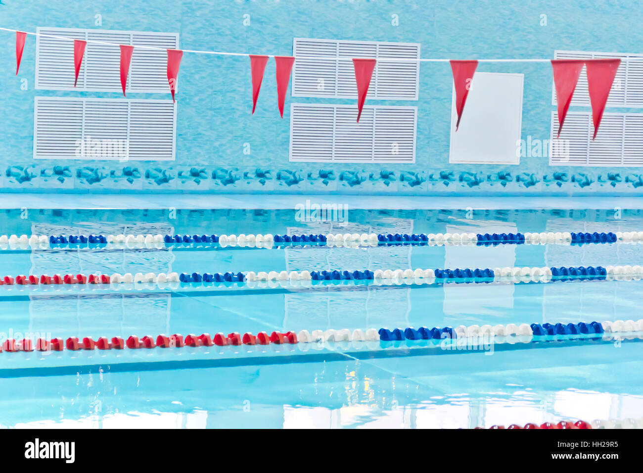 Photo of empty swimming pool with red flags Stock Photo - Alamy