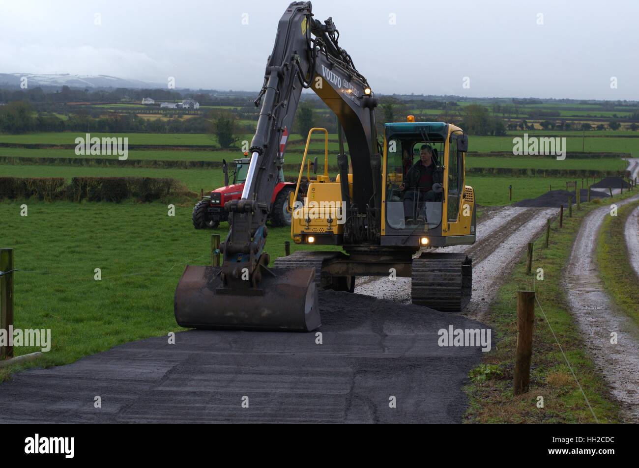 digger on the road Stock Photo - Alamy