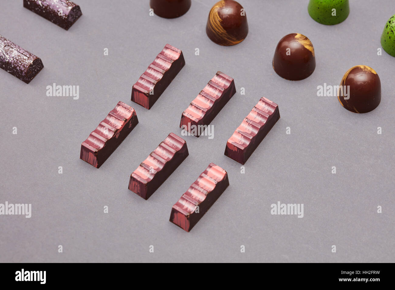 different size chocolate candy on a gray background Stock Photo - Alamy