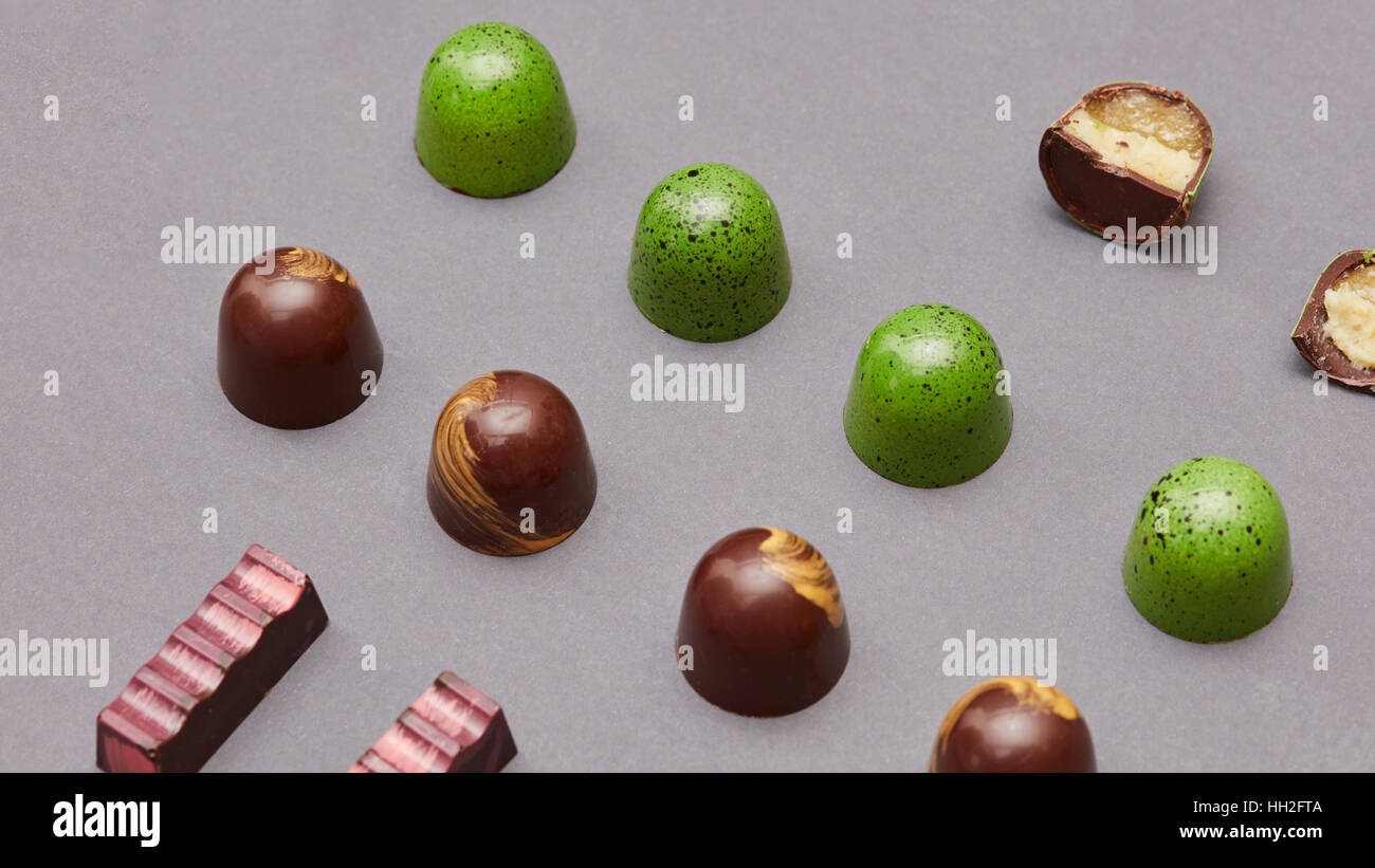 colored chocolate candies of different sizes on a gray background Stock ...