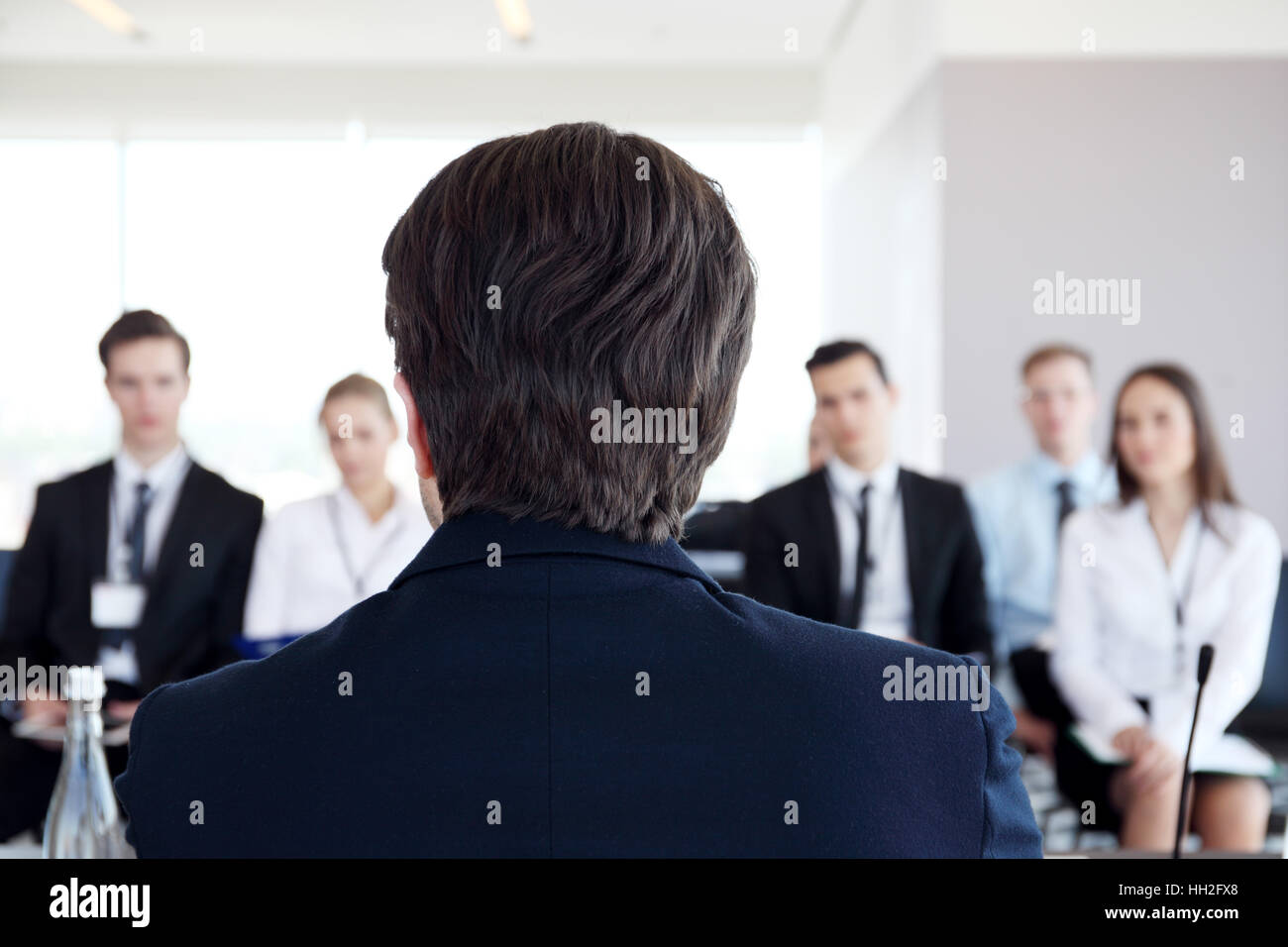 Speaker at business conference looking at audience waiting for ...