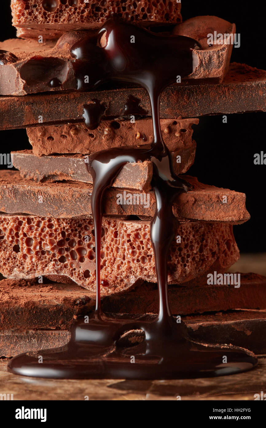 chocolate syrup dripping on stack dark chocolate Stock Photo - Alamy
