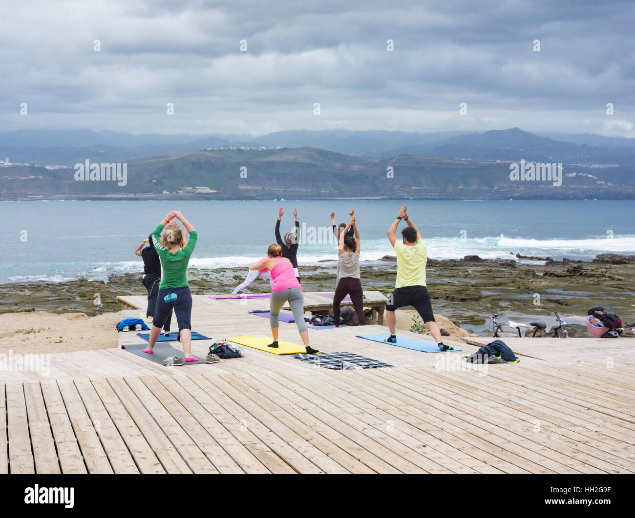 Yoga class overlooking sea Stock Photo - Alamy