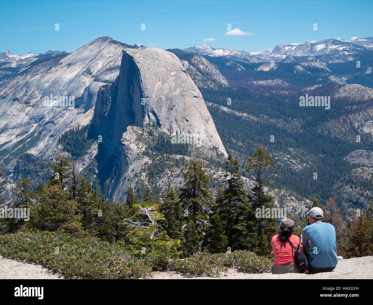 A couple looks over to Half Dome from Sentinel Dome Trail Stock Photo ...