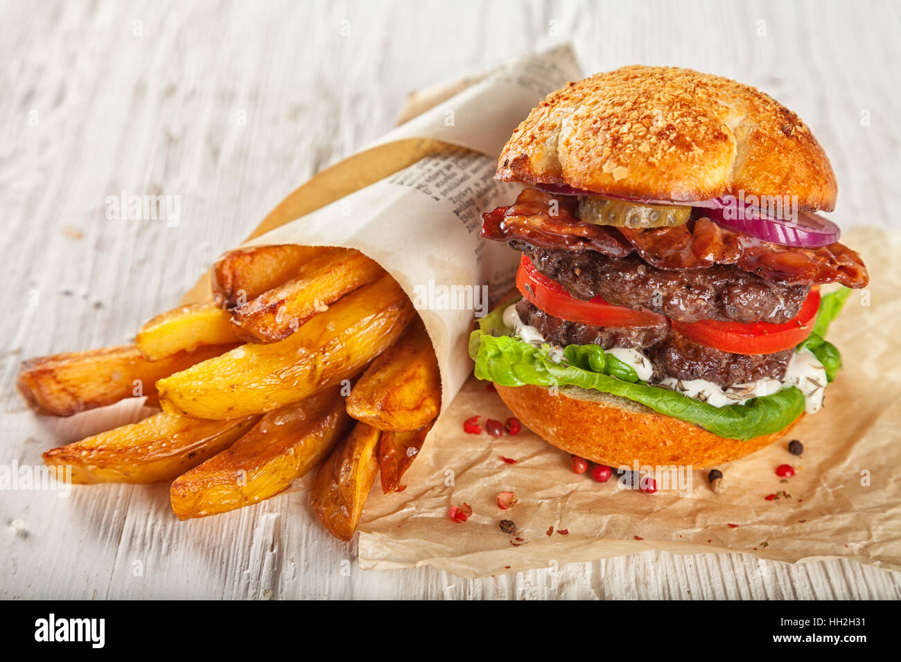 Home made hamburger with lettuce, cheese, beef meat and french fries ...