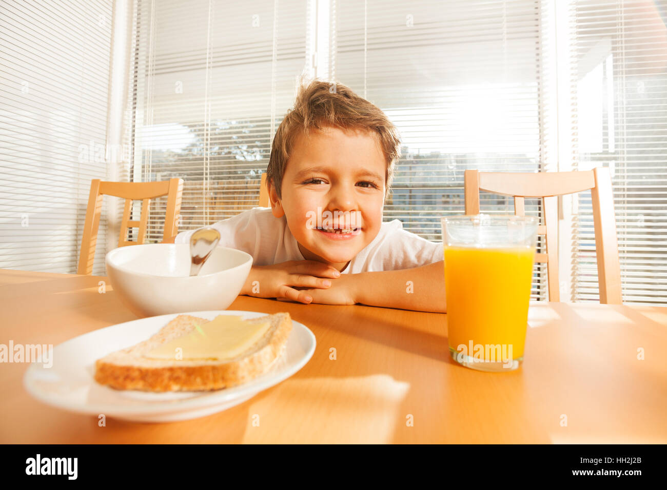 Happy boy waiting for his breakfast in the kitchen Stock Photo - Alamy