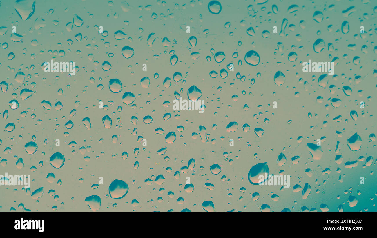 Rain drops on window with blue color background Stock Photo - Alamy