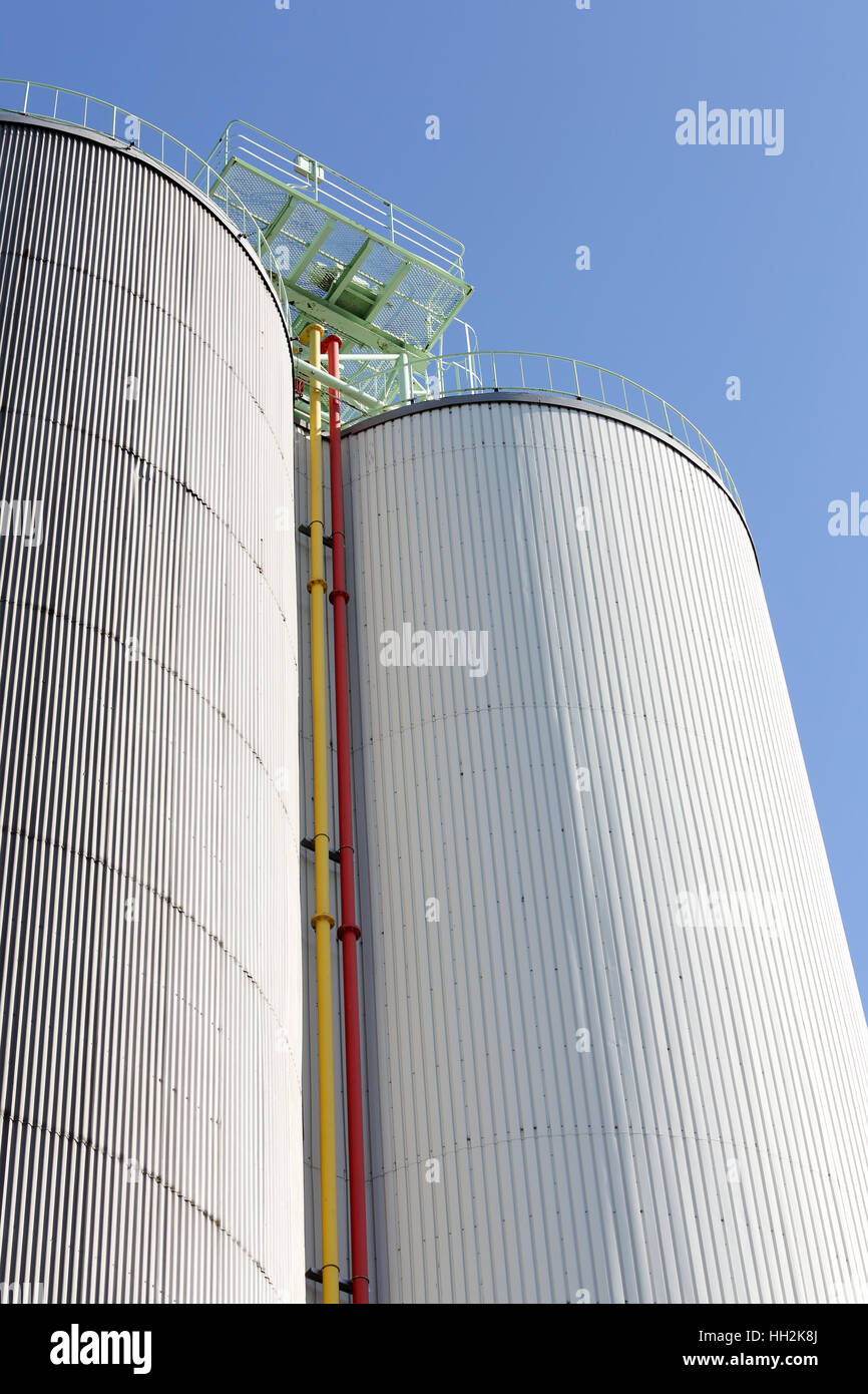 Industrial storage silo against clear blue sky Stock Photo - Alamy