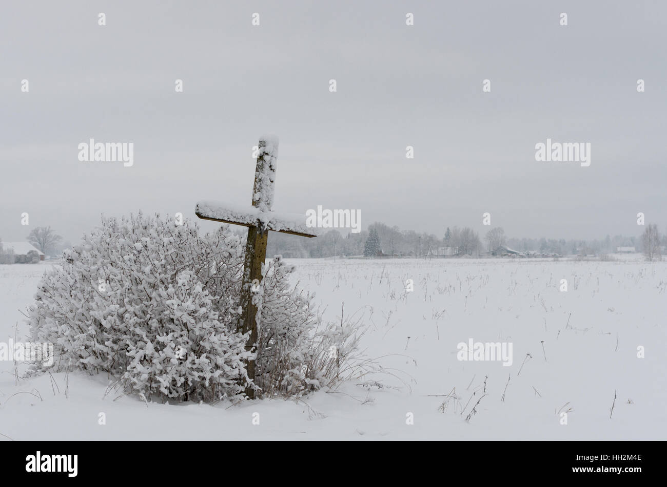 Old weathered wooden catholic cross on a snowy meadow Stock Photo - Alamy