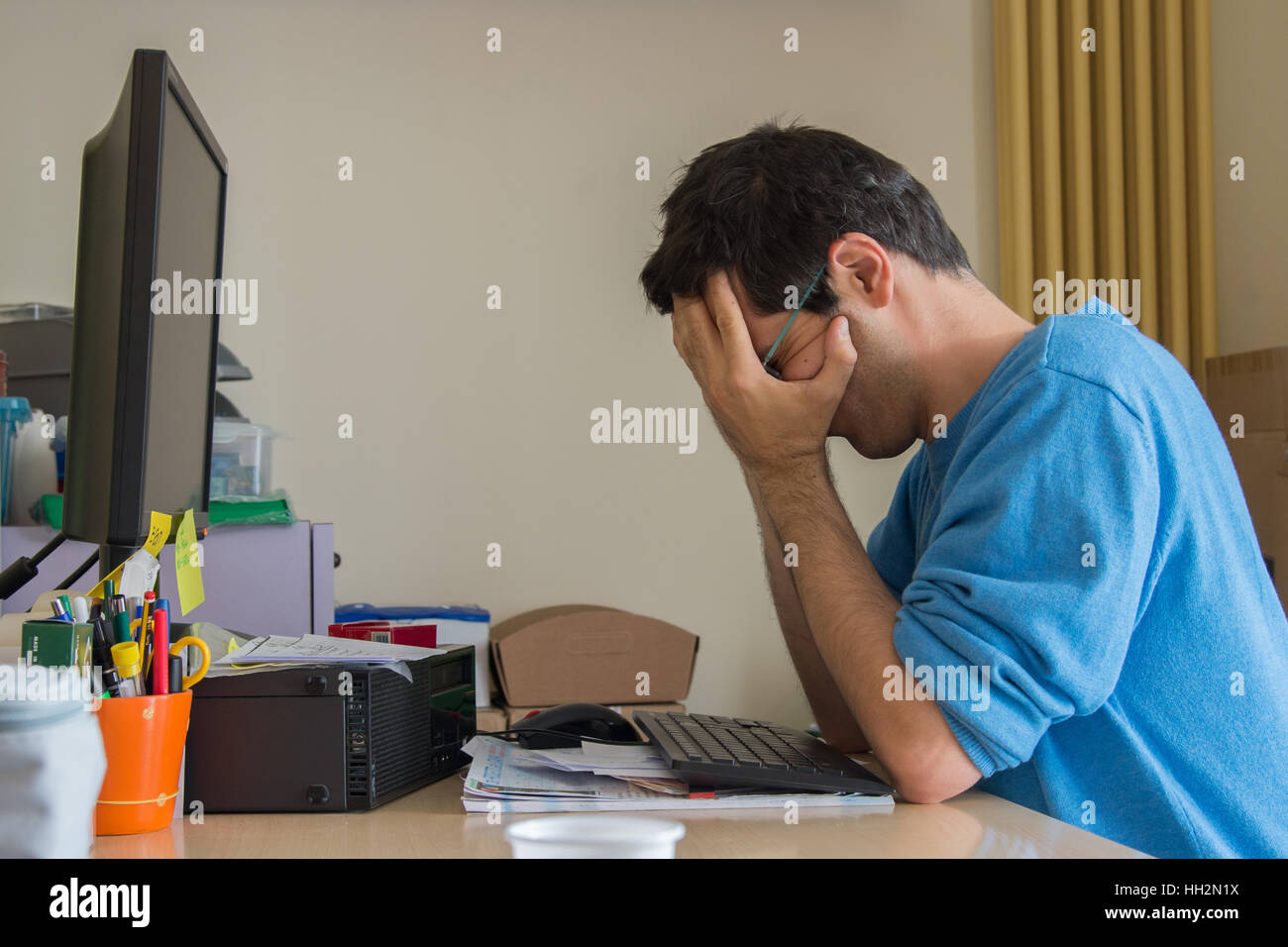 Stressed man at work into the office Stock Photo - Alamy