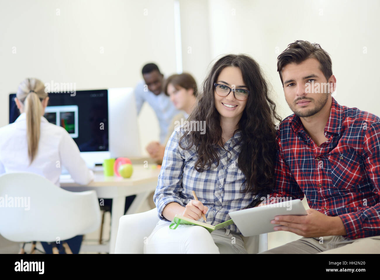 business couple working together on project at modern startup office ...
