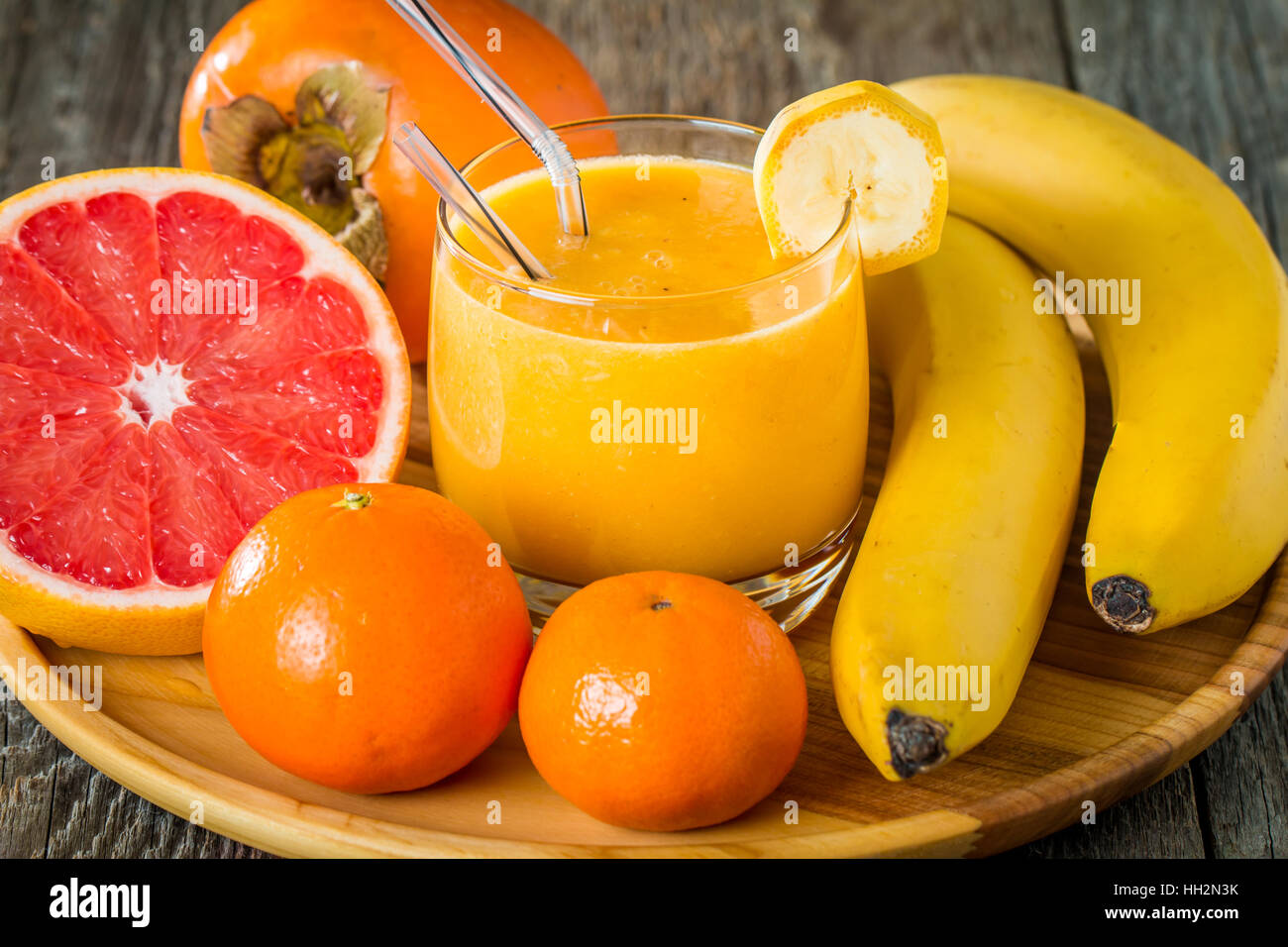 Fresh made yellow smoothie with banana, grapefruit, tangerine ...