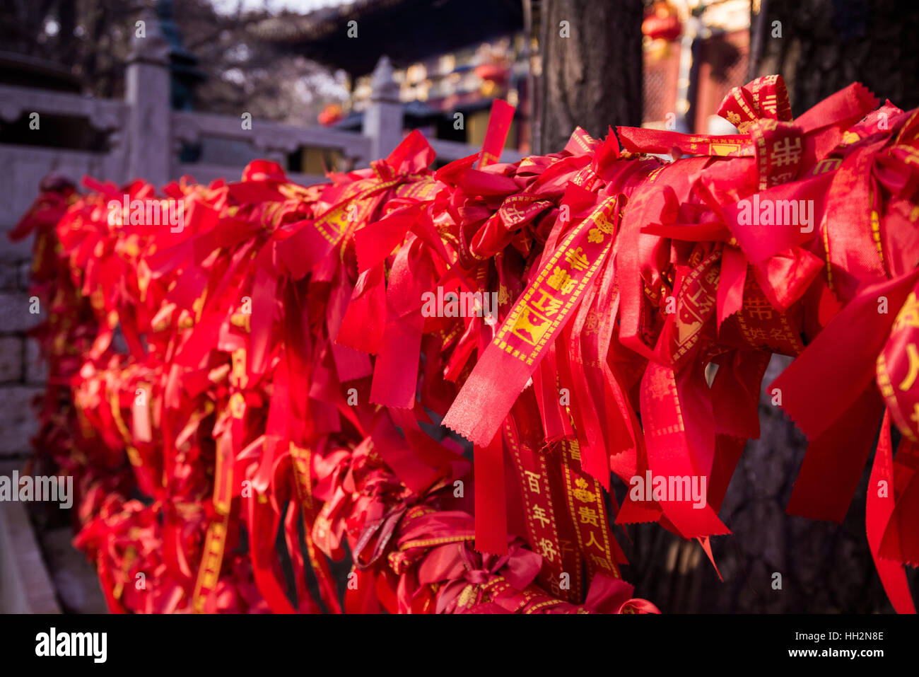 Chinese red ribbons on a fence in Buddhist temple Stock Photo - Alamy