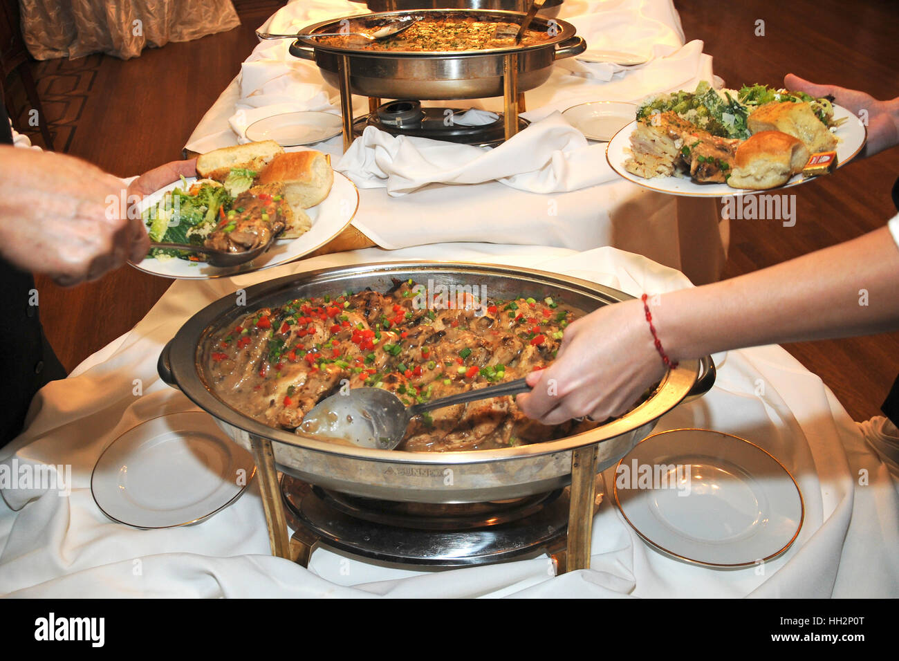 People serving themselves buffet hi-res stock photography and images ...