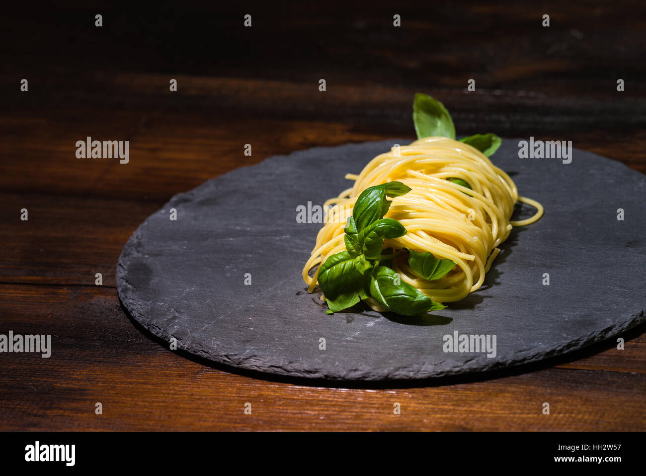 Photo of Delicious basil wrapped in spaghetti pasta Stock Photo - Alamy