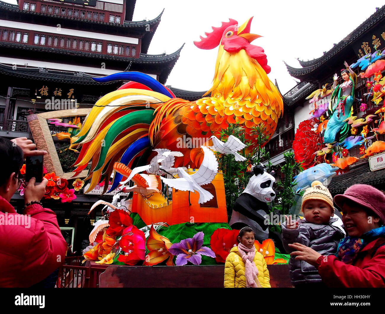 Shanghai, China. 15th Jan, 2017. People pose for photos with the ...