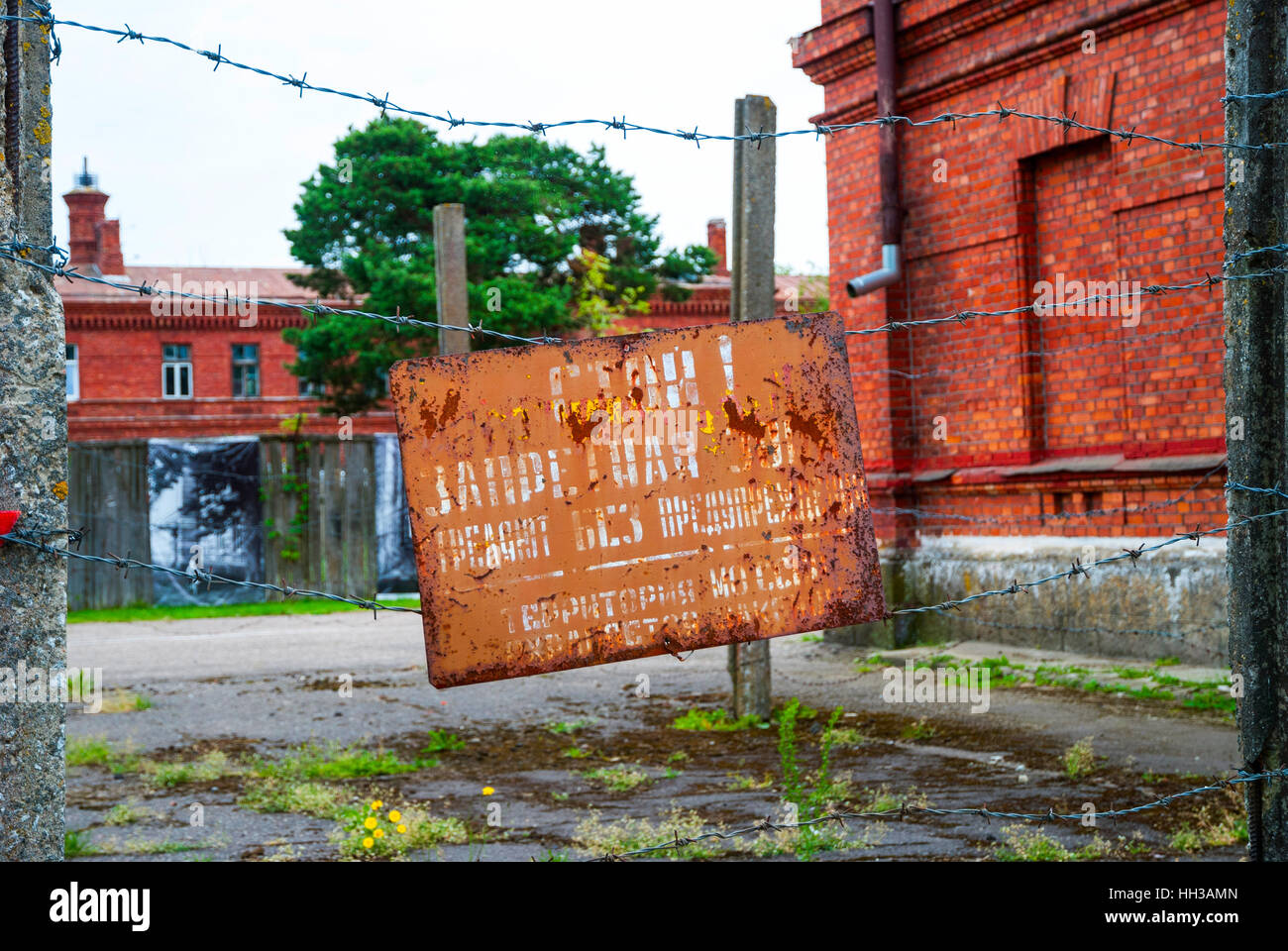 Close-up of rusty worn-out board on wire at prison entrance in Liepaja ...