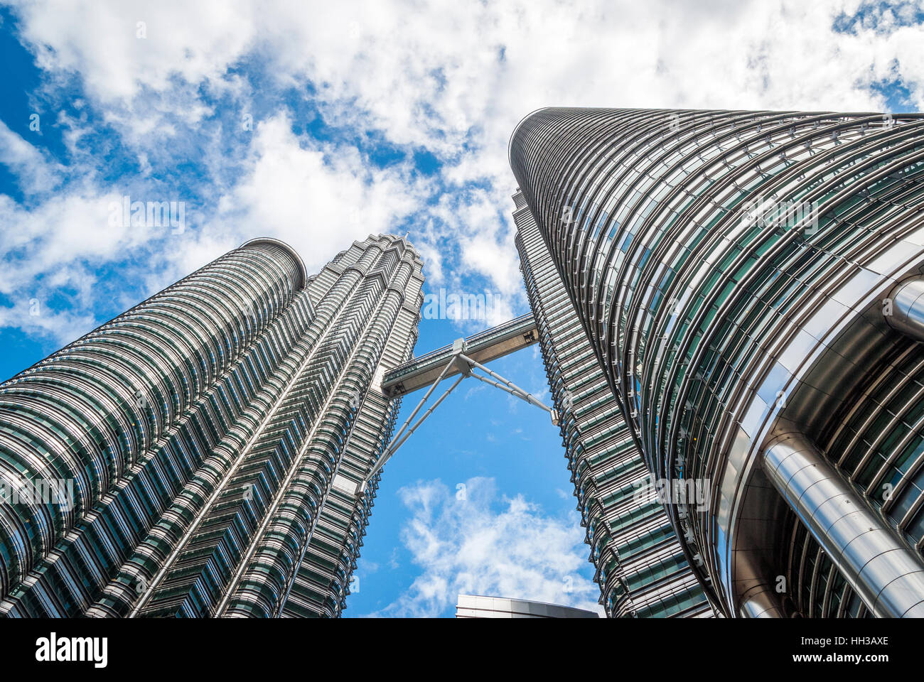 View on famous high-rise Petronas twin tower with bridge from below ...