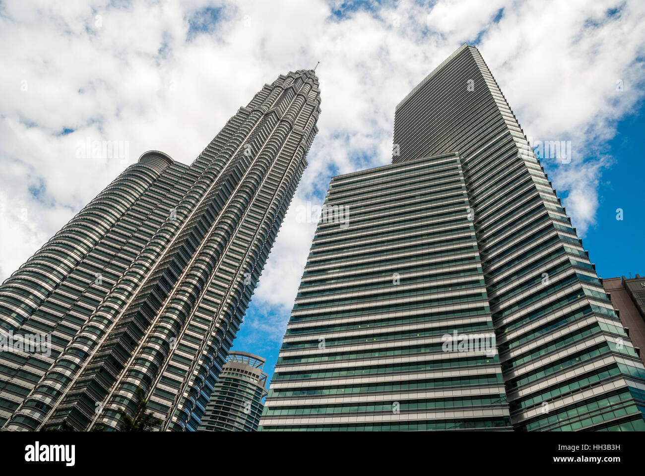 View on famous high-rise Petronas twin tower with bridge from below ...
