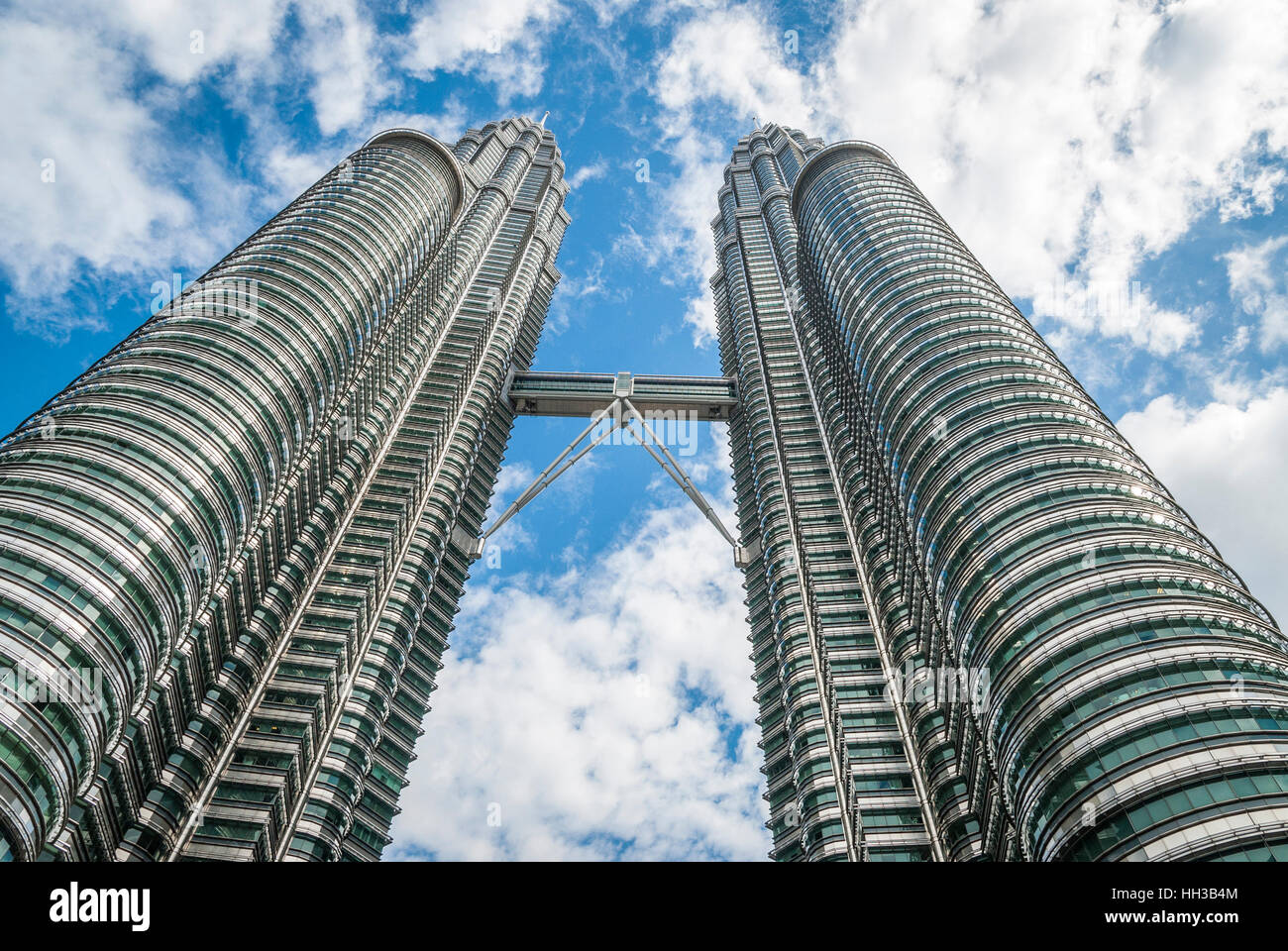 View on famous high-rise Petronas twin tower with bridge from below ...