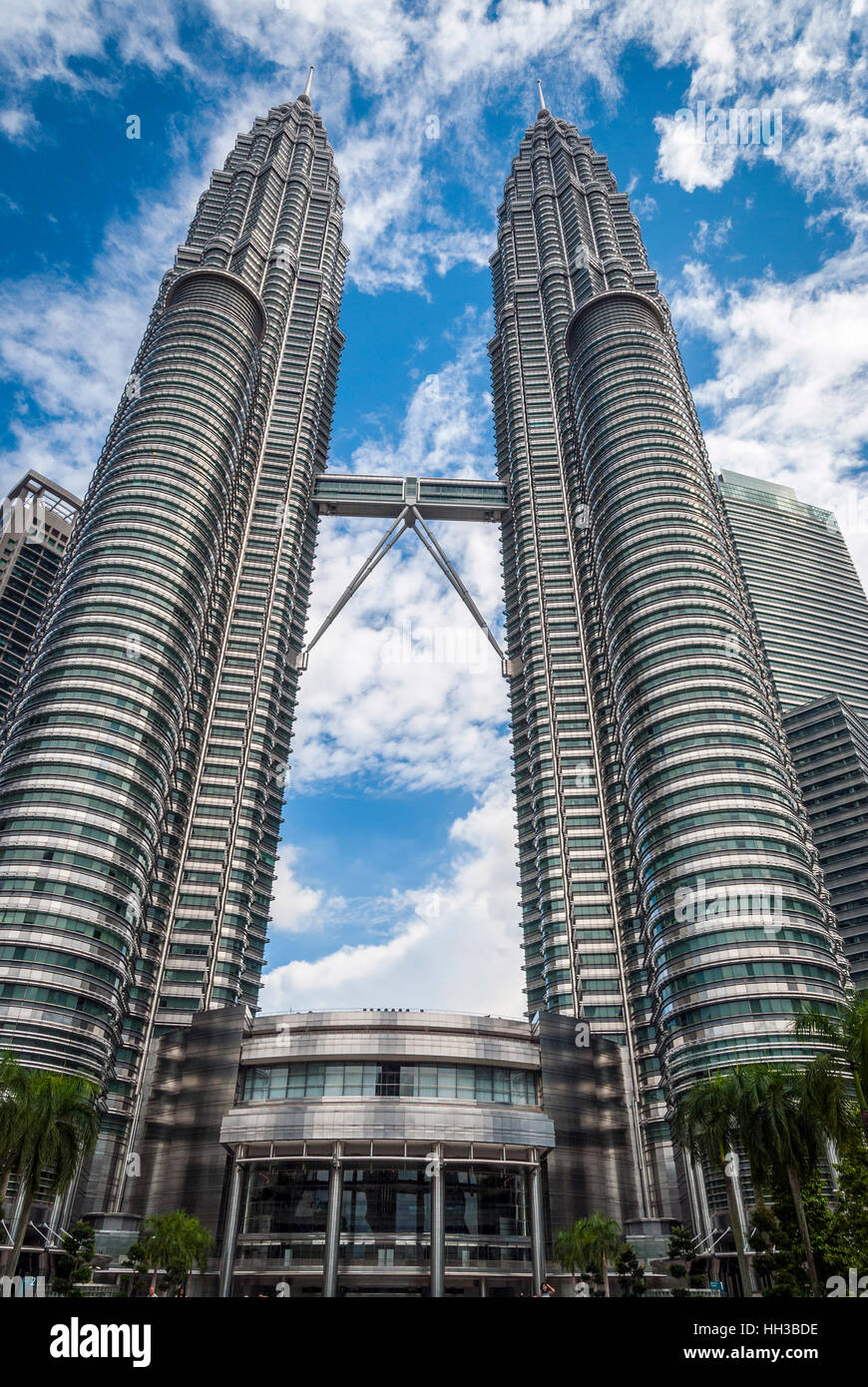 View on famous high-rise Petronas twin tower with bridge from below ...