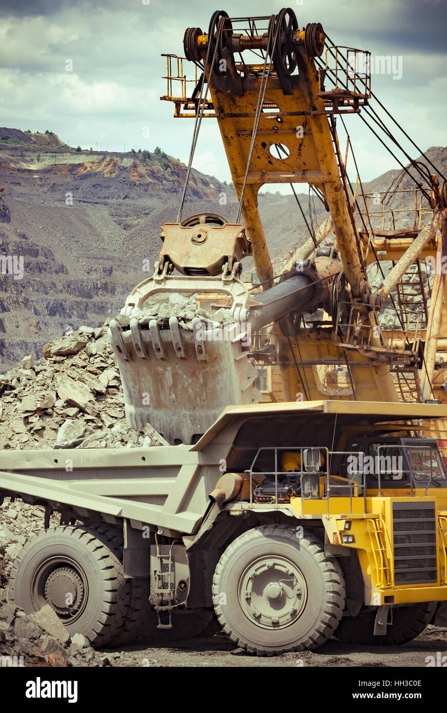 Heavy mining truck and excavator developing the iron ore on the ...
