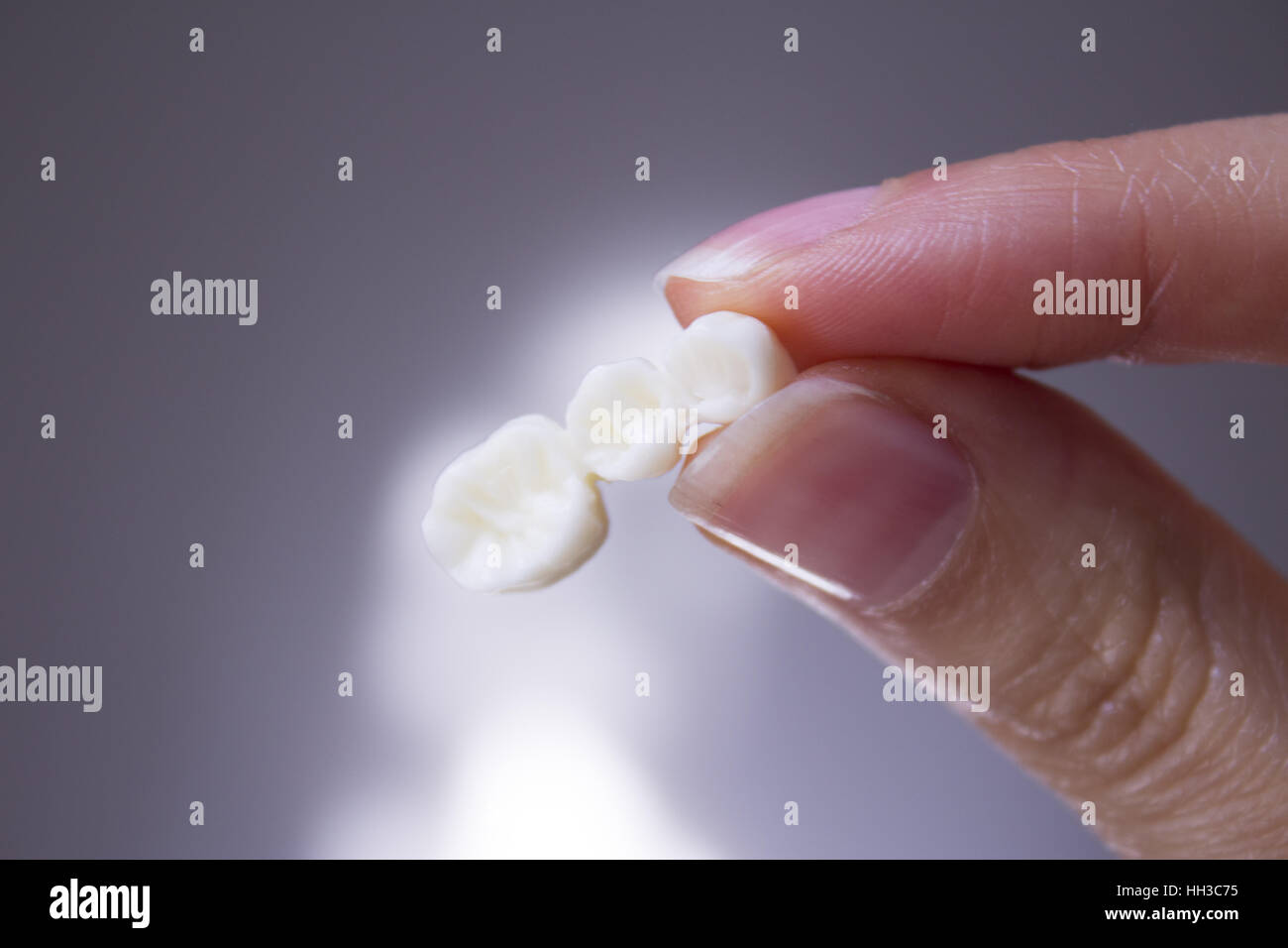 Woman holding false teeth hi-res stock photography and images - Alamy