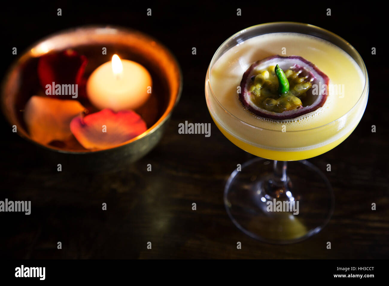 Floating candle with rose petals by an exotic cocktail served at The ...