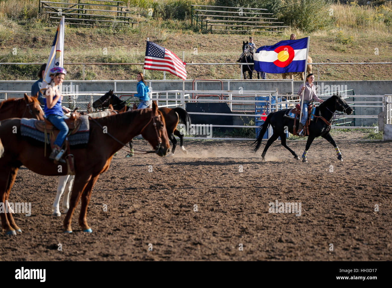 Young ladies riding horses and carrying flags during opening ceremonies ...