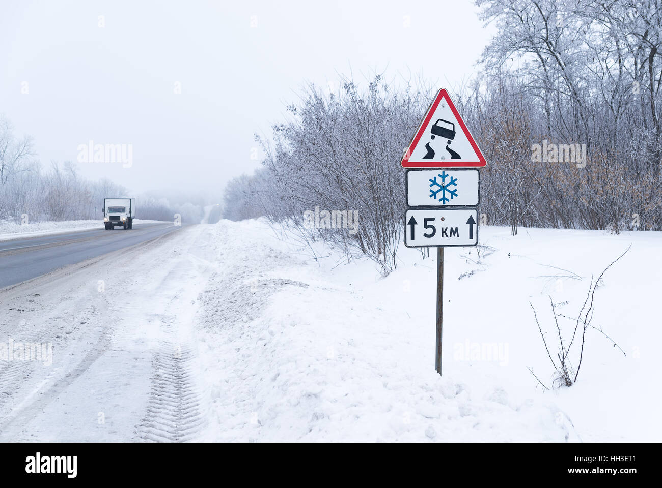 The road sign is on the snowy side Stock Photo - Alamy