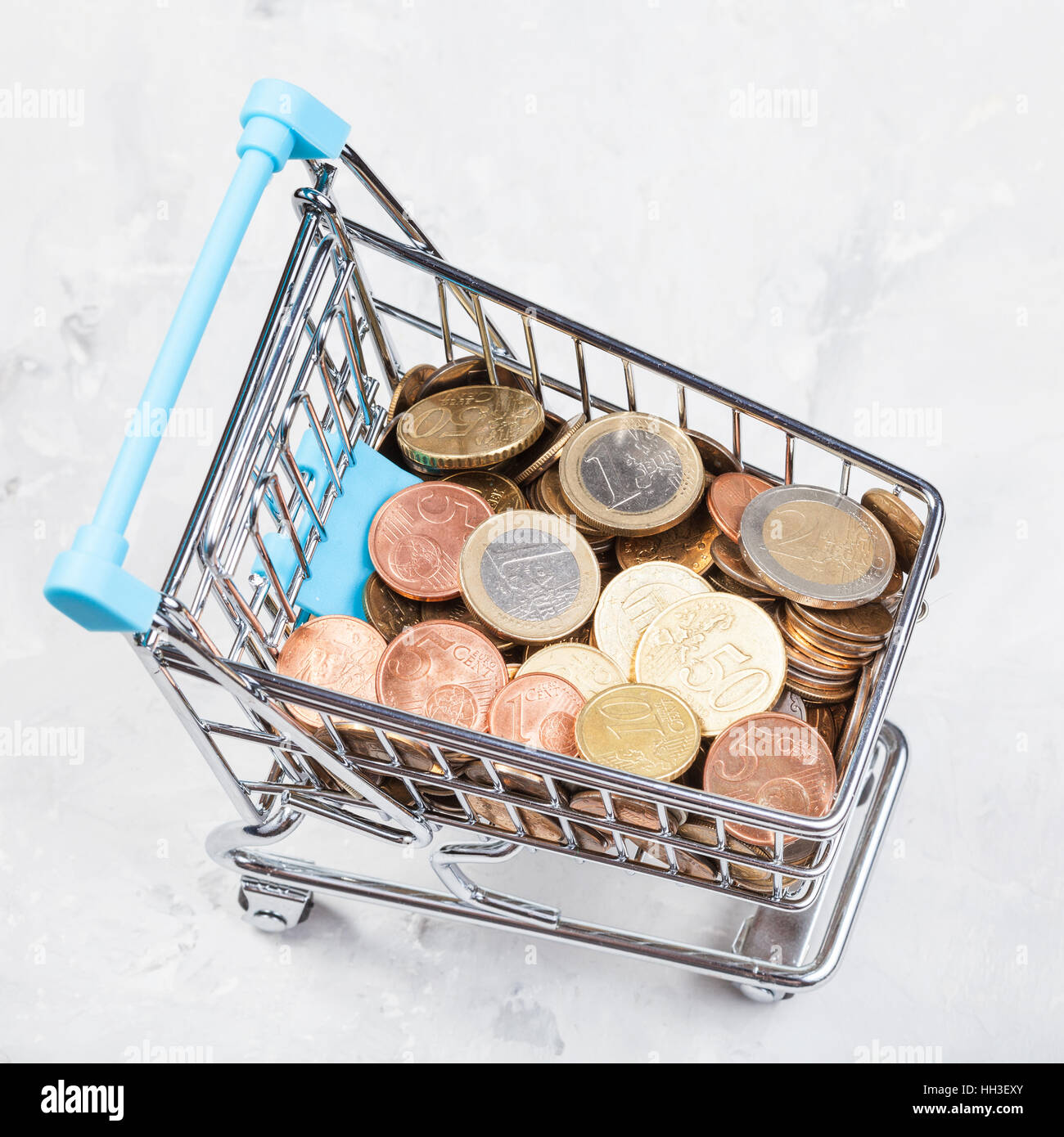 shopping trolley with euro coins on concrete plate Stock Photo - Alamy