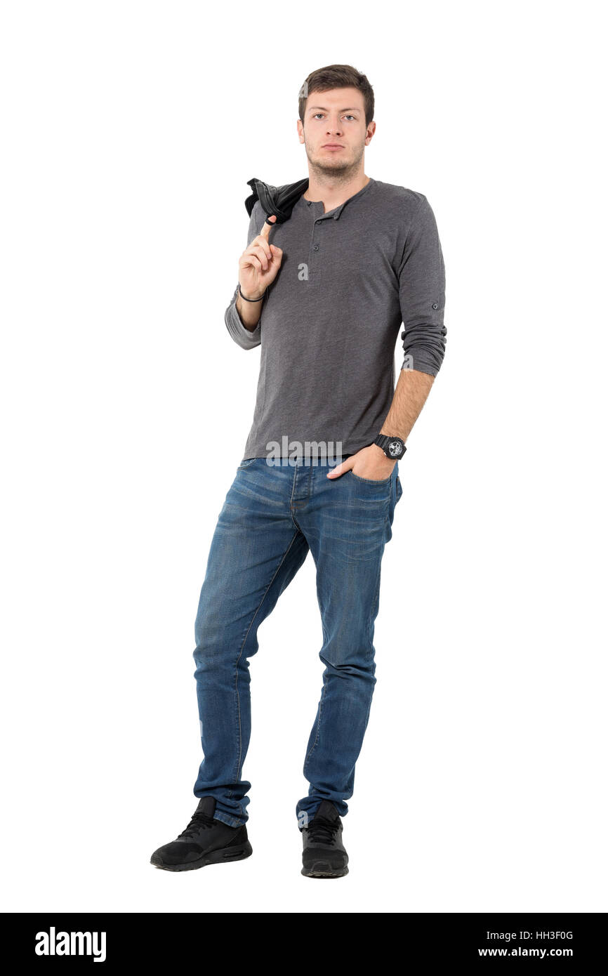Handsome casual man carrying jacket over shoulder looking at camera ...