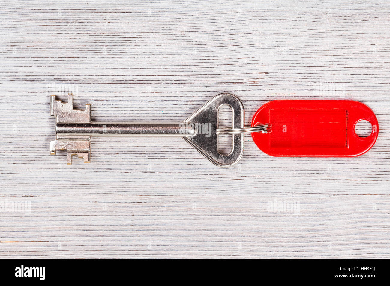 big door key with red blank keychain on wooden table Stock Photo - Alamy