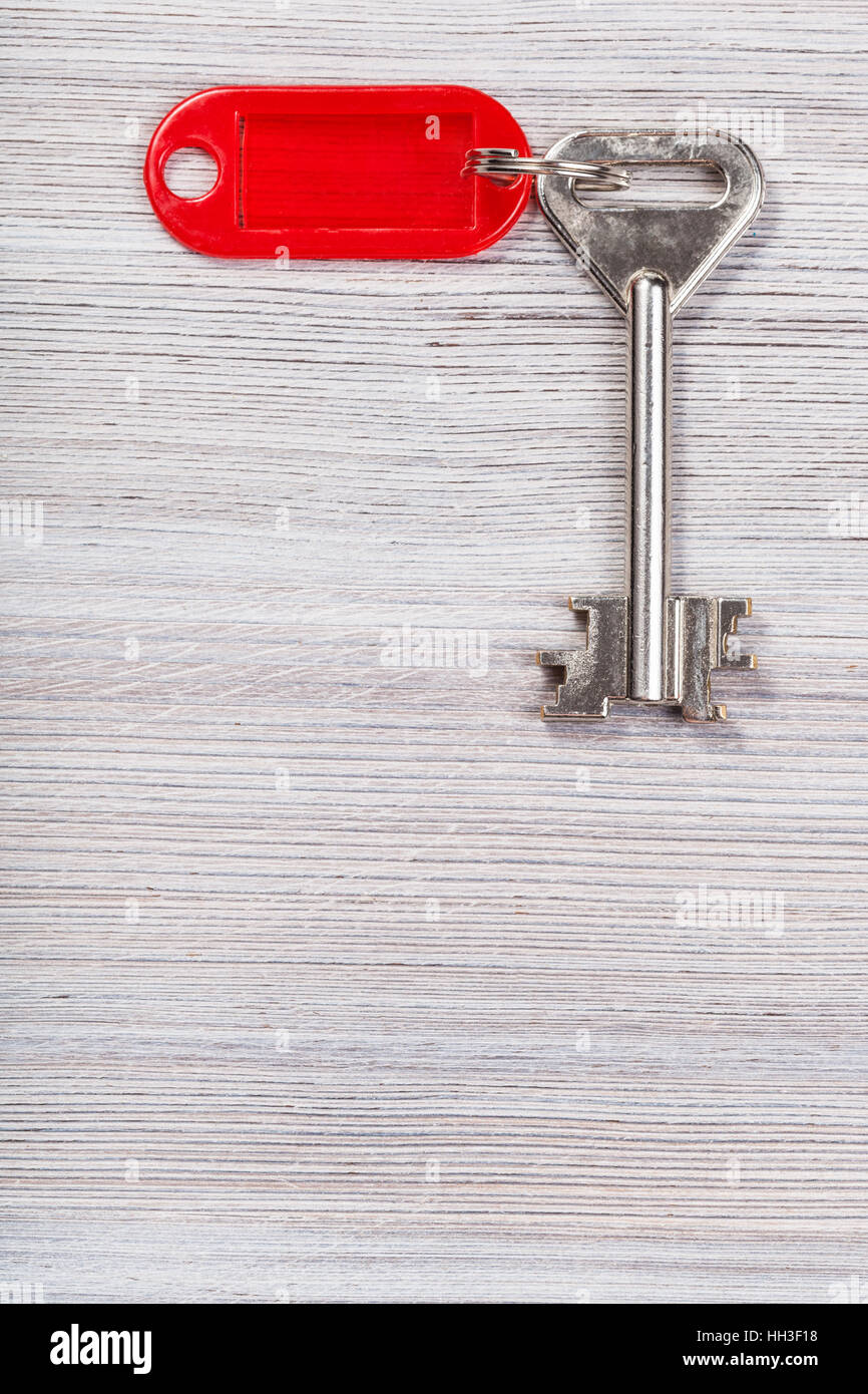 big door key with red blank key chain on wooden surface Stock Photo - Alamy